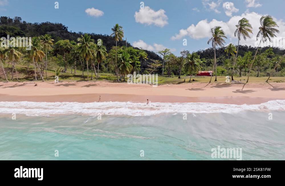 Tourist At Playa Colorada With Foamy Sea Waves In Las Galeras, Samana ...