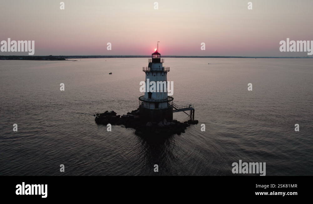 Aerial ascending video revealing sunset from behind the Conimicut Point ...