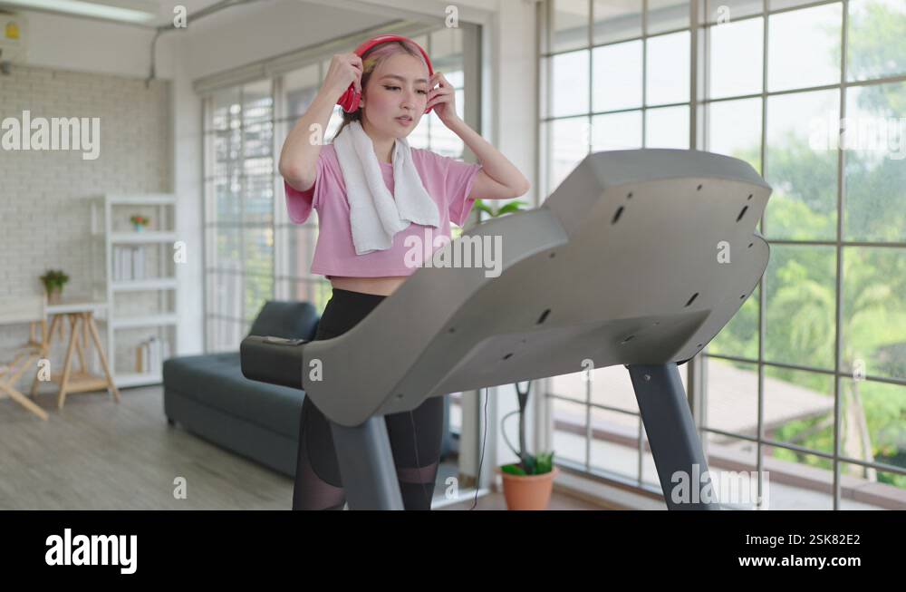 Women in headphones waving hands, showing muscle, talking video call ...