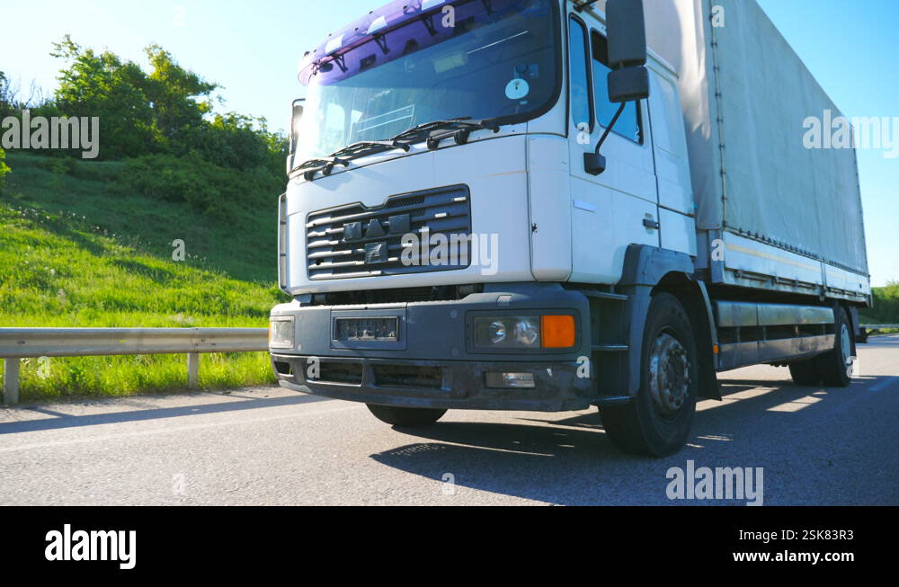 Big truck with cargo trailer driving on highway and transporting goods ...