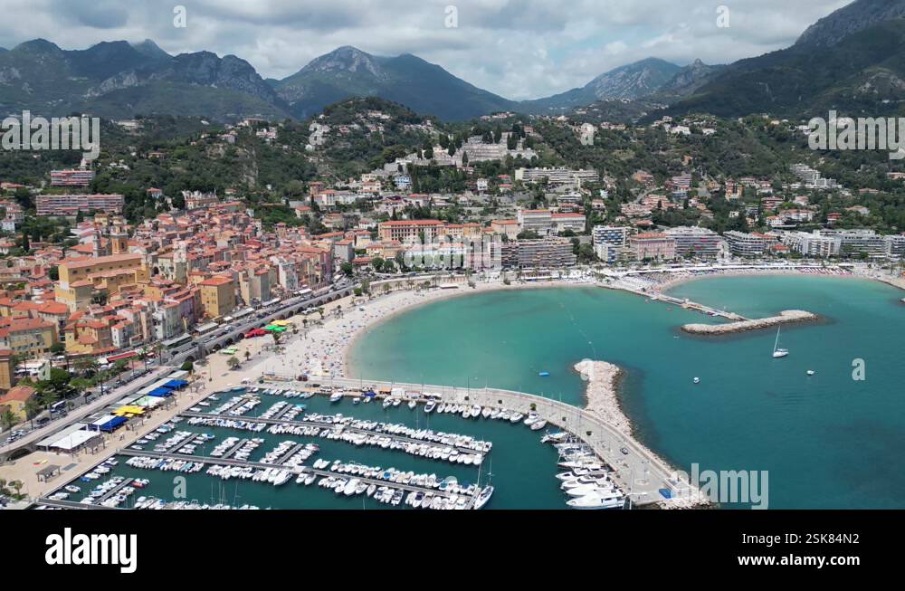 Plage des Sablettes beach in Menton France and old town with boat ...