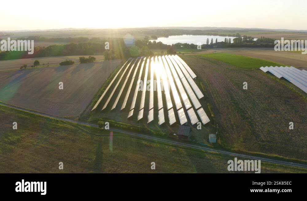 Aerial view from a drone - solar panels in a field by a road in a rural ...