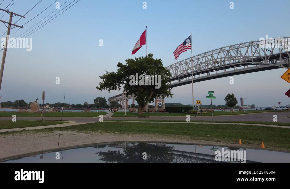 Canadian American Bridge Border Crossing With Flags Blowing In Wind At ...