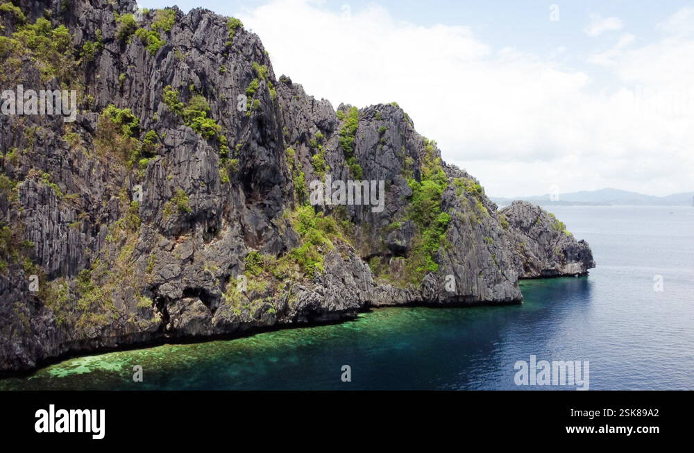 Ascending aerial above Palawan Island cliffs Bangka Boat Route Stock ...