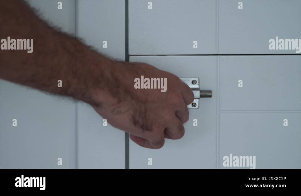 Man's hand locking a bathroom door in slow motion. Close up shot Stock ...