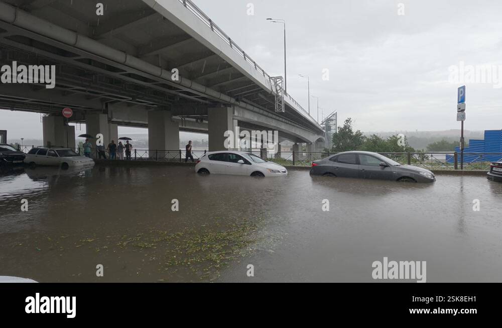 city roads and cars flooded in the rain. malfunction of storm sewers in ...