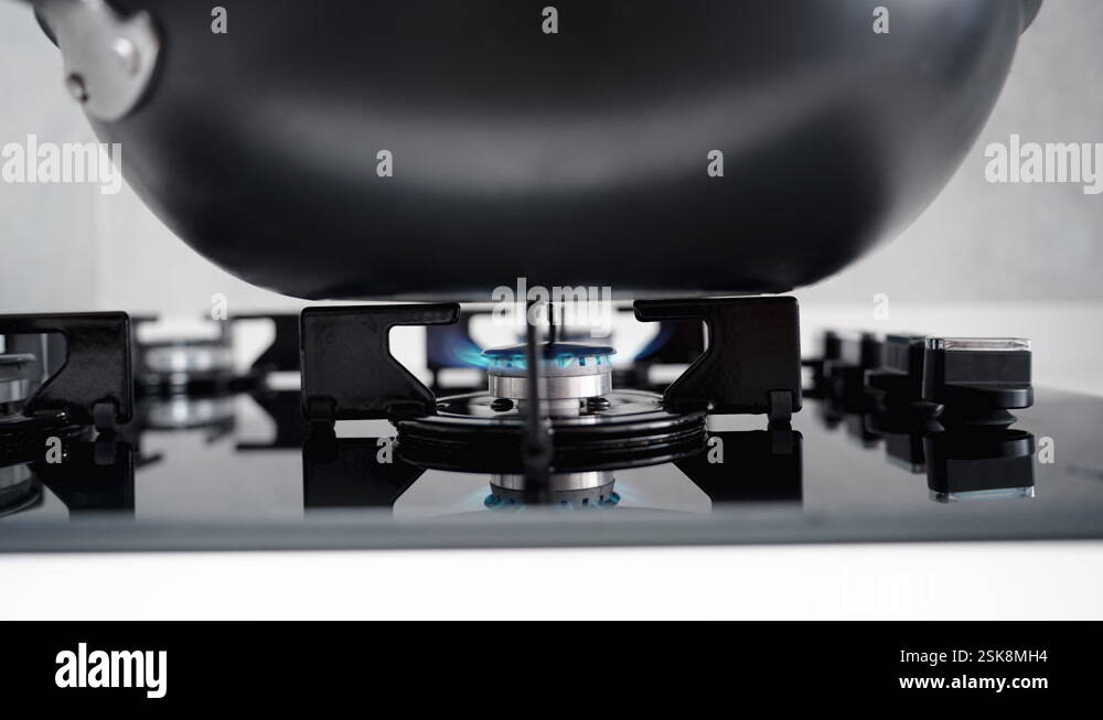 In the pristine white kitchen, something is being cooked in a large pot ...