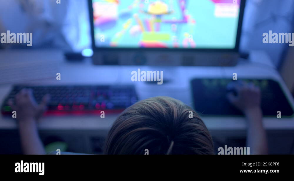 Gamer's head in a chair. He looks into the bokeh monitor, the picture ...