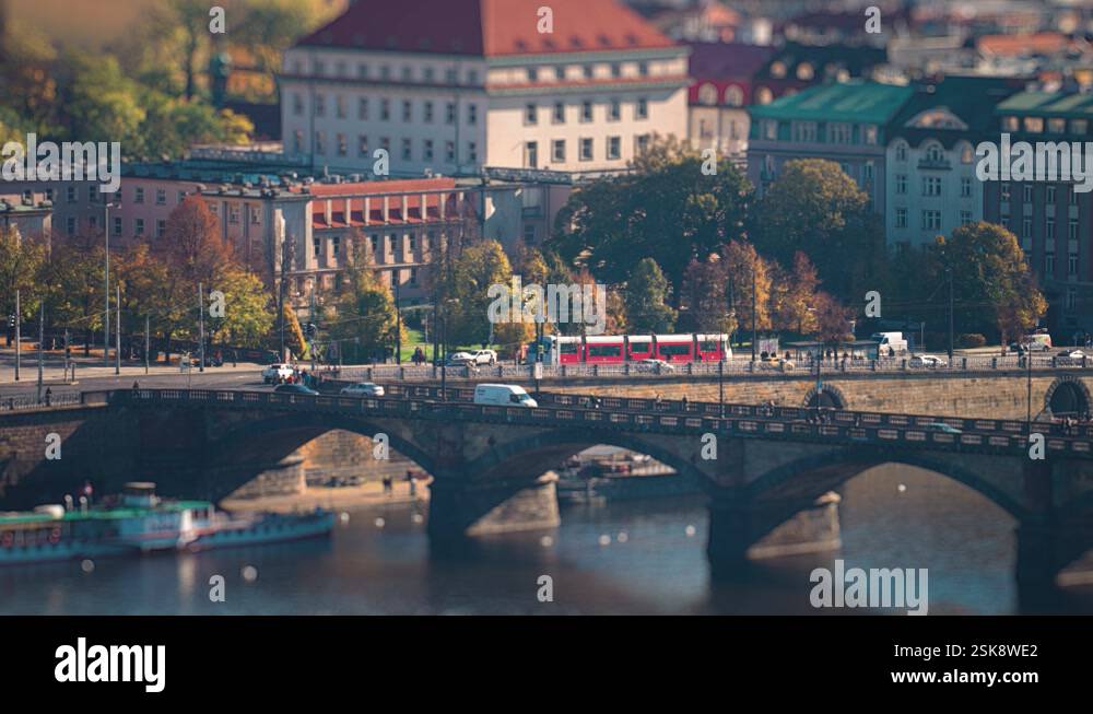 Miniaturized trams and cars move along miniaturized bridges and streets ...