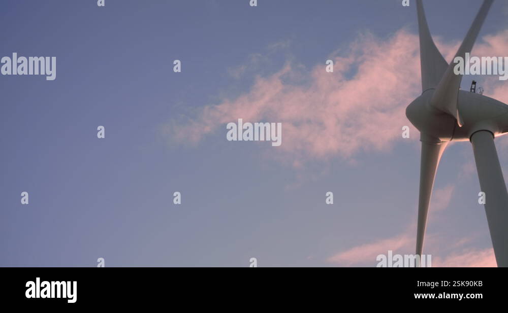 Wind turbine windmill turning in a blue sky with clouds Stock Video ...