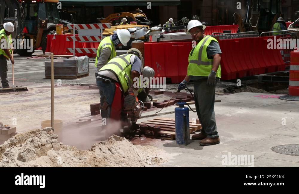 workman using masonry saw to cut paving bricks Stock Video Footage - Alamy