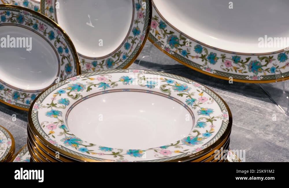 New expensive shiny porcelain plates with gold trim stacked in a ...