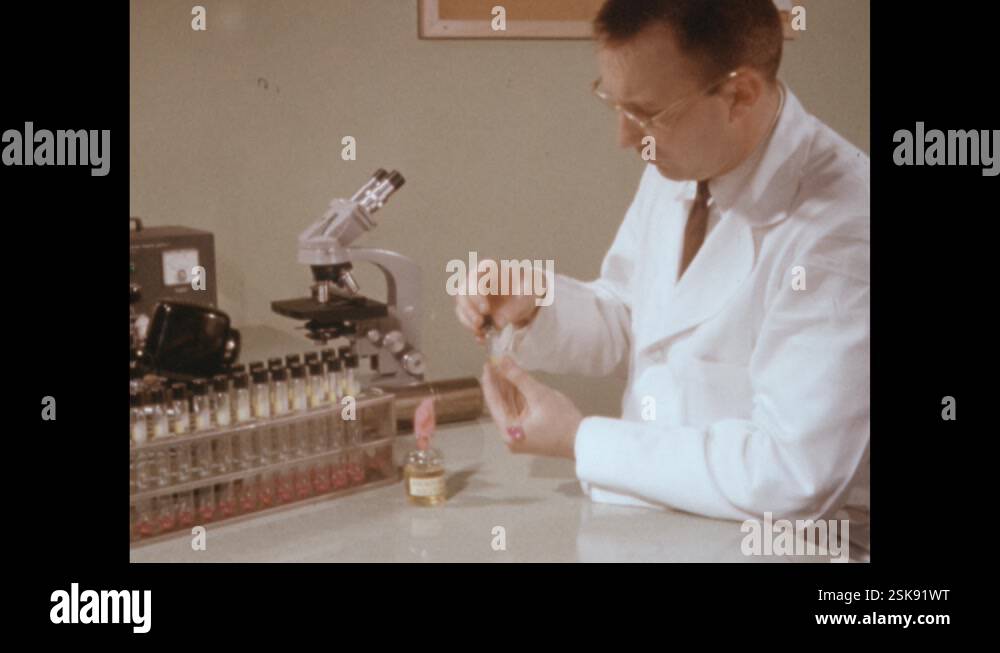 1960s: Man in laboratory takes test tube and loosens top Stock Video ...