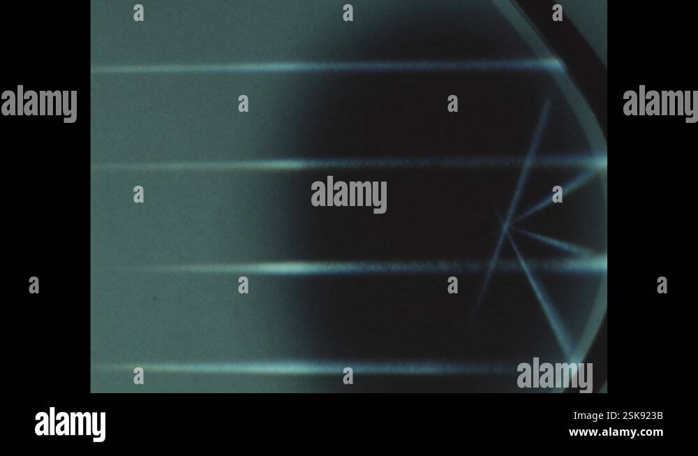 1960s: Light beams reflect off of arched metal instrument in laboratory ...