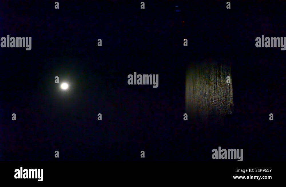 Glowing white moon and moon path on water surface of sea black night ...