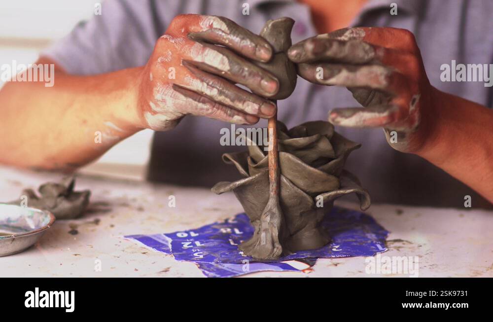 Sculptor man creating sculpture from clay in workshop. Process of ...
