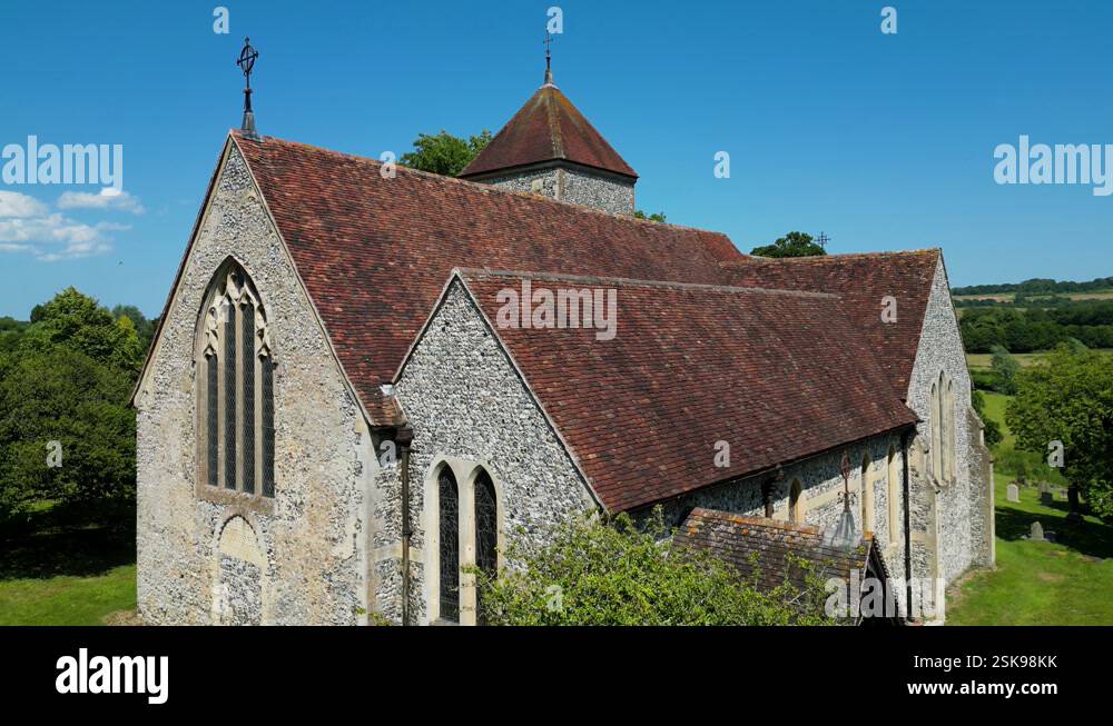 A rising boom-shot of St Lawrence the Martyr church in Godmersham ...