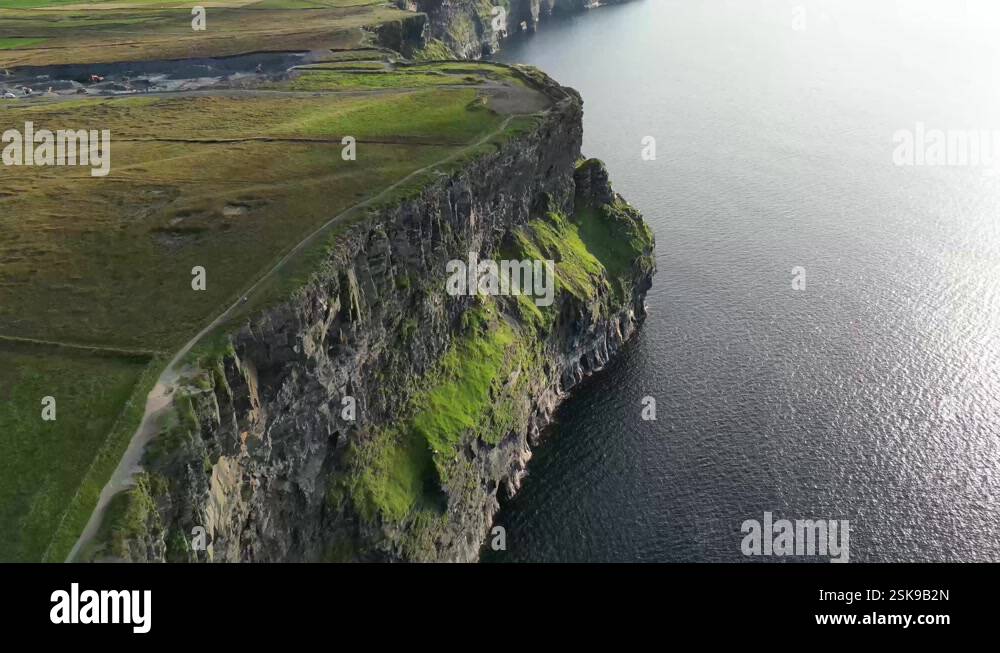 Drone shot of the Cliffs of Moher at sunset, looking down from above ...