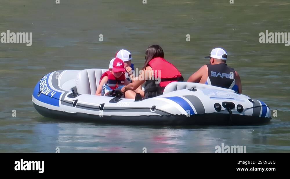 Rafters from bowness park floating on the Bow River during a hot summer ...