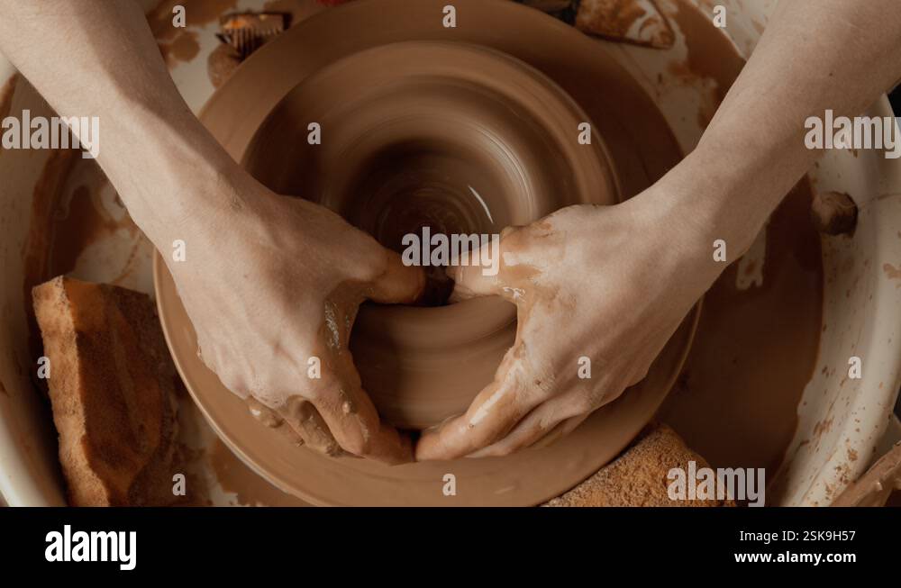 Potter making ceramic bowl on pottery wheel. Top view. Potter shape ...