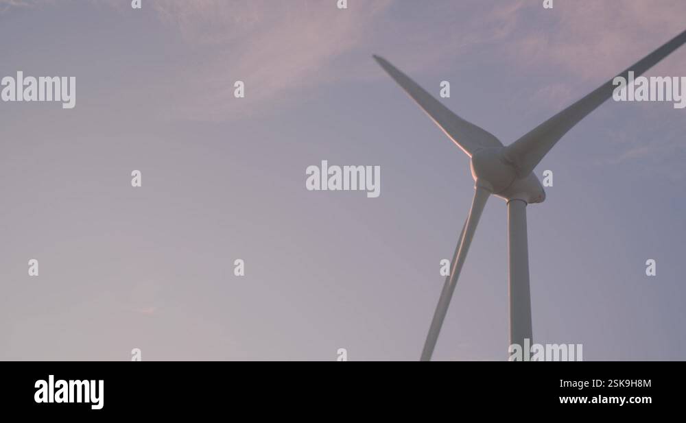 Wind turbine windmill turning in a blue sky with clouds Stock Video ...