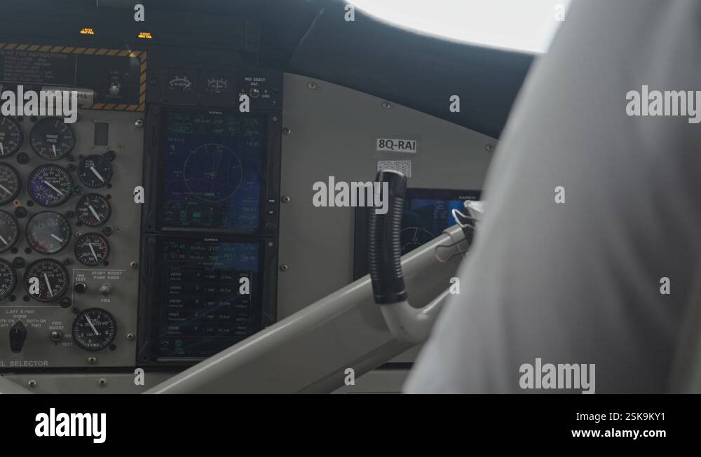 Behind pilot looking at control wheel of small airplane with modern ...