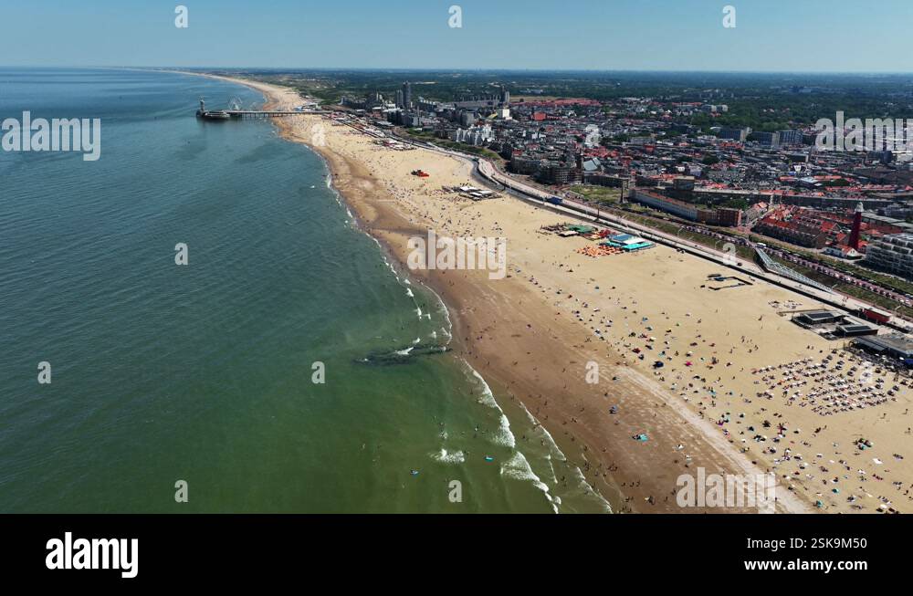 Beachgoers enjoying hot summer day at Scheveningen beach, Den Haag ...