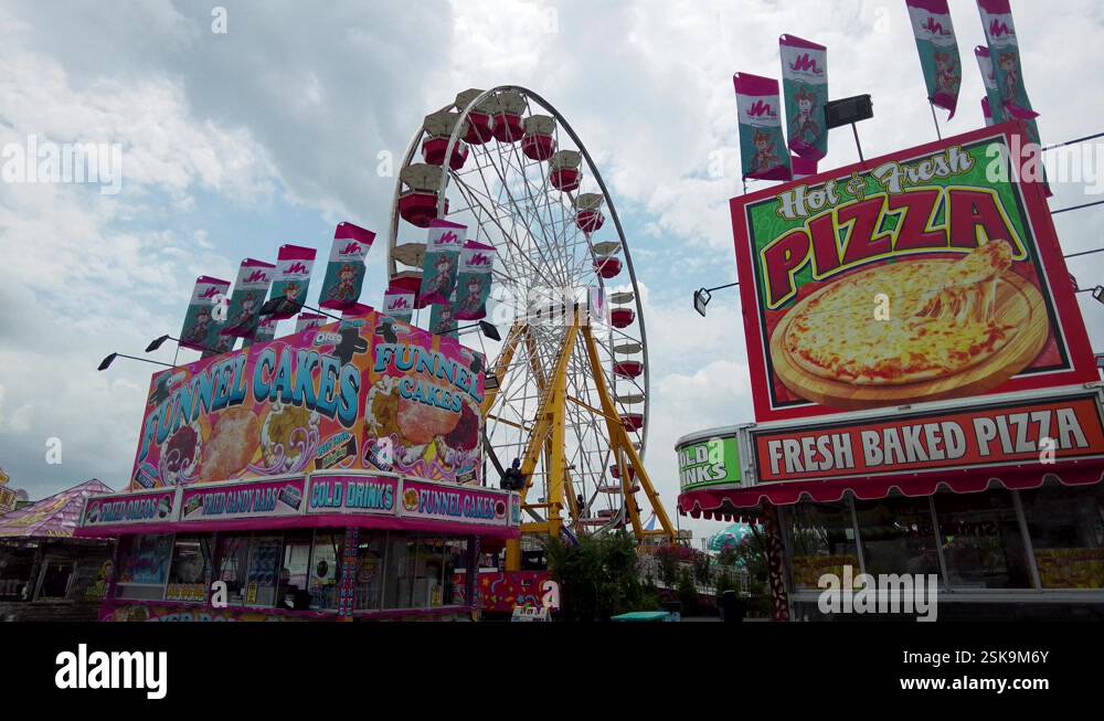 Carnival state fair deep fried food stands ferris wheel big clouds ...