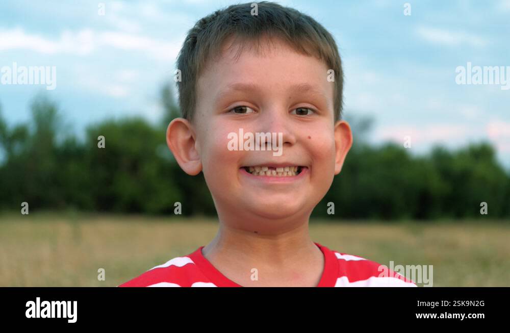 Funny preschooler boy without tooth smiles widely posing for camera in ...