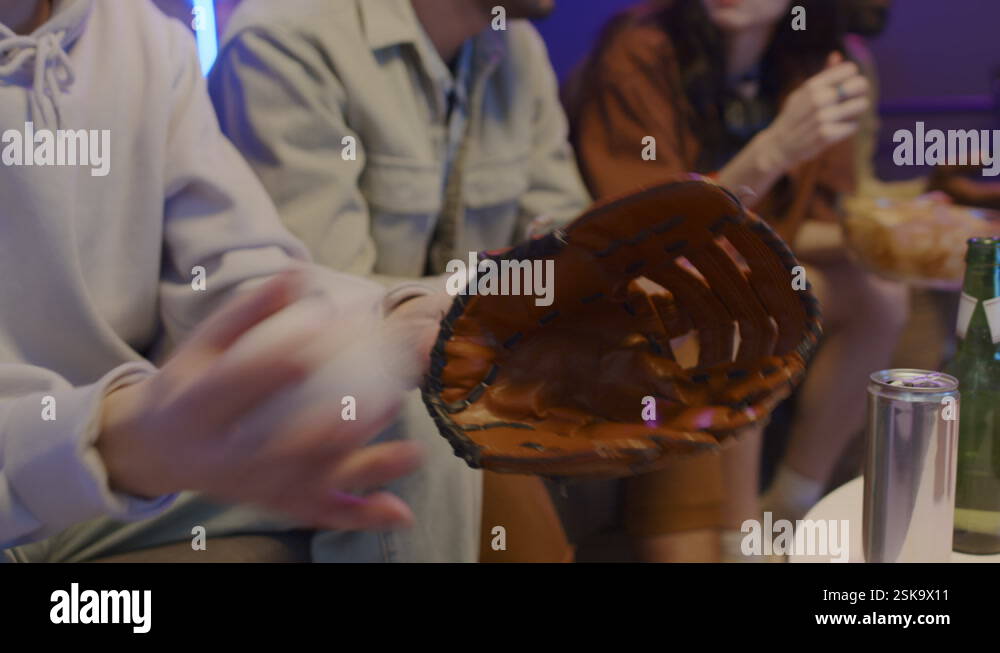 Anonymous Man Fiddling with Baseball and Glove while Watching Match ...
