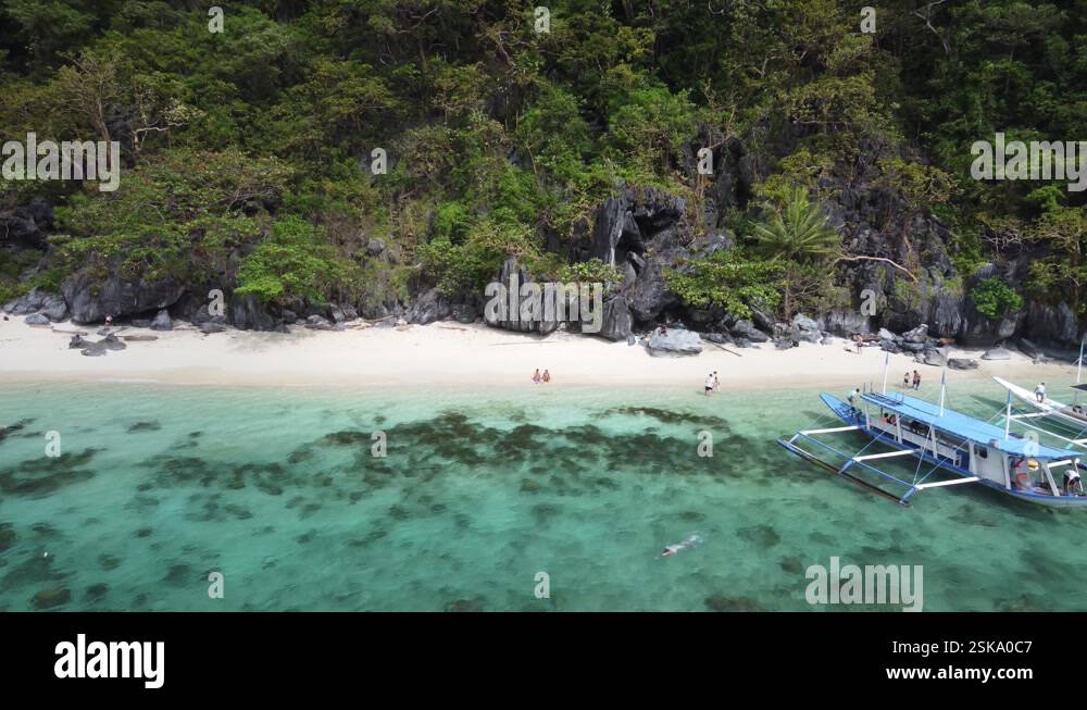 Holidaymaker tourists of two island hopping tour boats snorkeling and ...