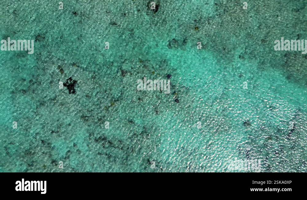 Drone footage flying slowly over the rippling surface of a tropical ...