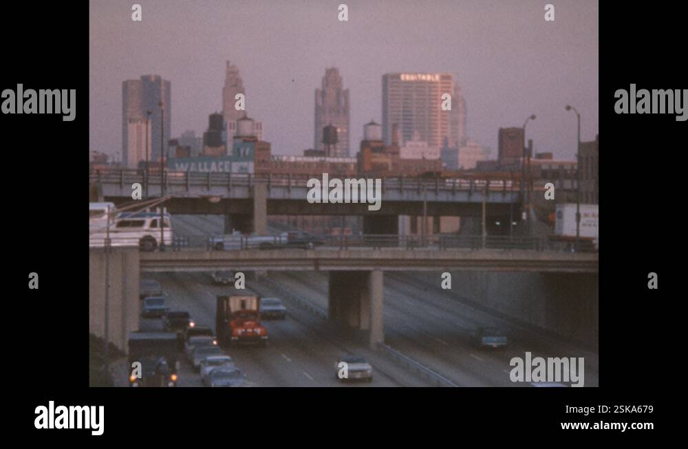 1960s: Highway overpasses with traffic in front of downtown city core ...