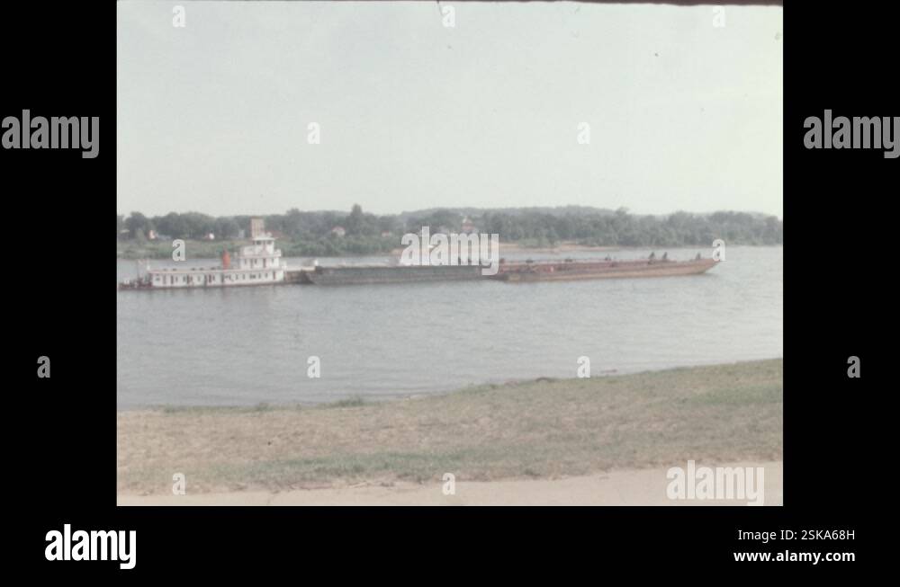 1960s: Boat pushes barge down river Stock Video Footage - Alamy