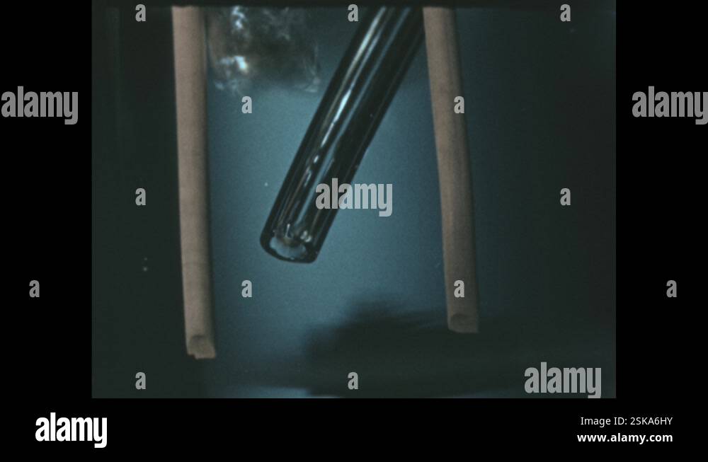 1960s: Air bubbles escape glass tube and rise upwards in tank of water ...