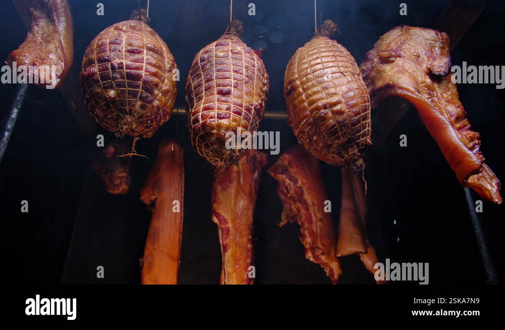 Low angle view of half done smoked pieces of pork like ribs and pork ...