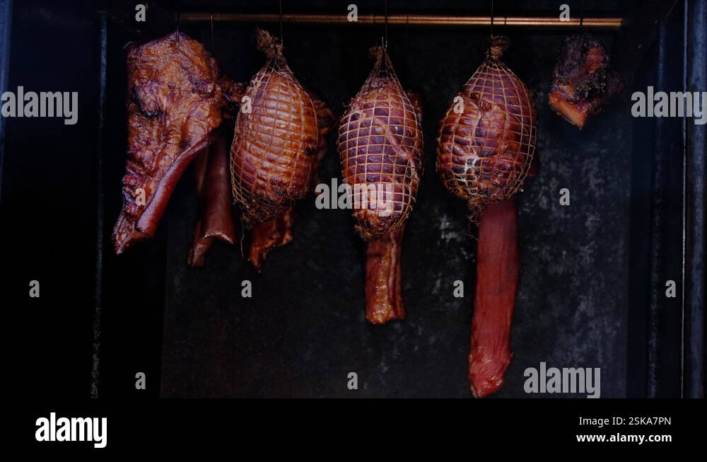 Heavy smoked pieces or pork like ribs and pork belle and hams hanging ...