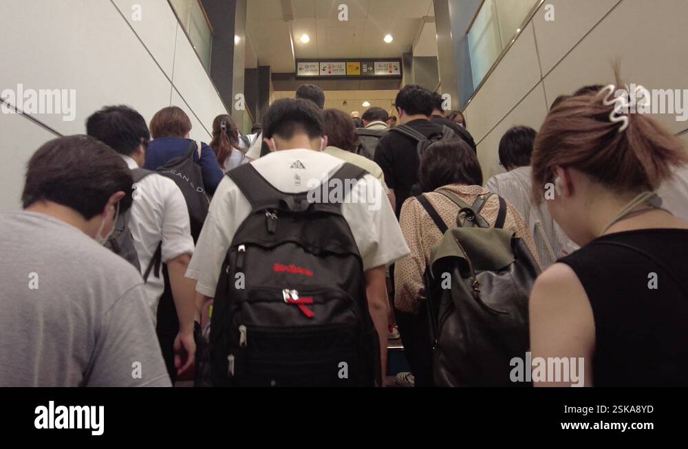 Crowd of people walking up a stairs at Shinagawa station in busy ...