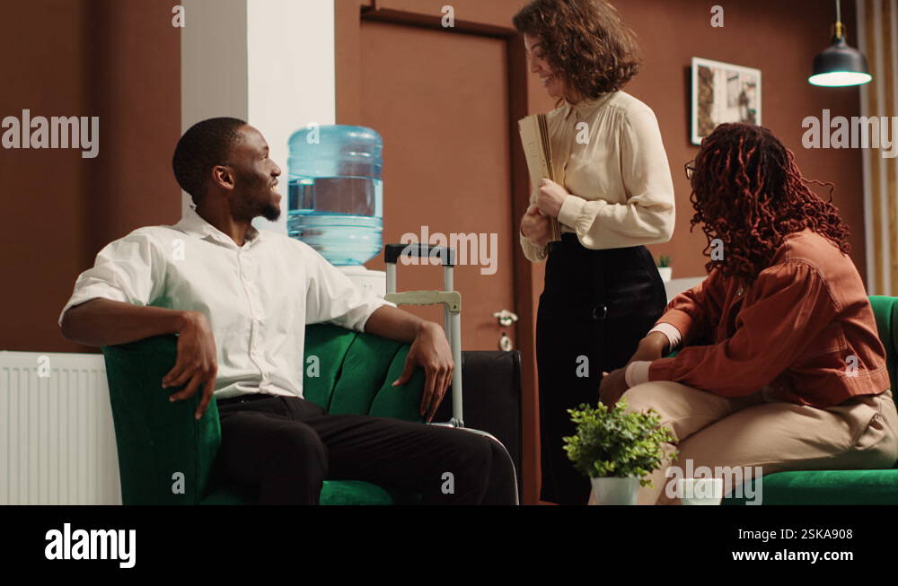 Hotel manager greeting tourists Stock Video Footage - Alamy