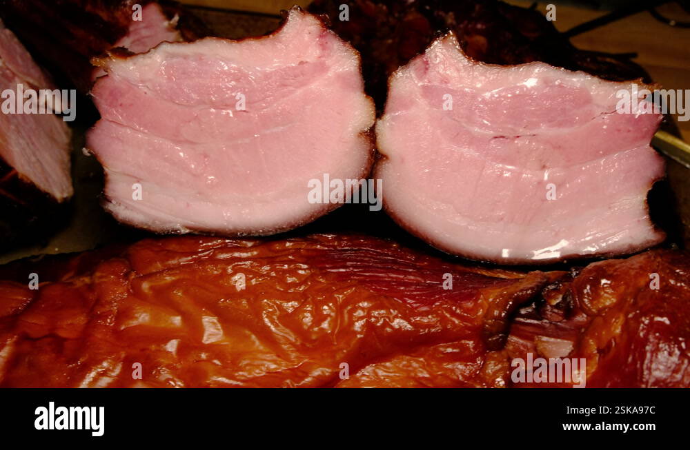 Close up while panning right to left of smoked bacon cut in half Stock ...