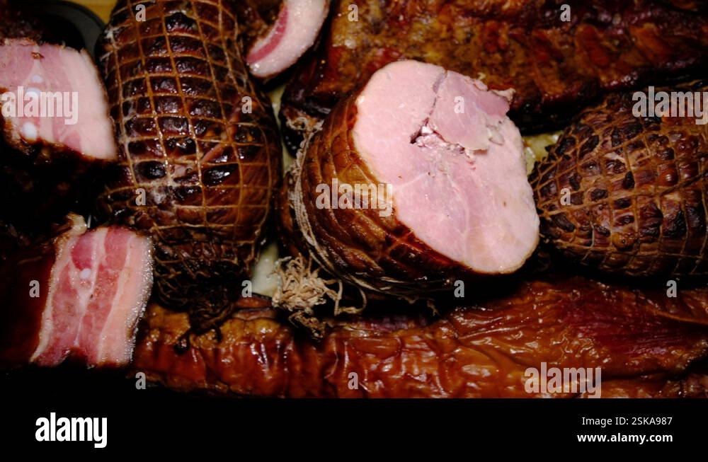 Close up while moving camera above smoked ham and other meat cuts Stock ...