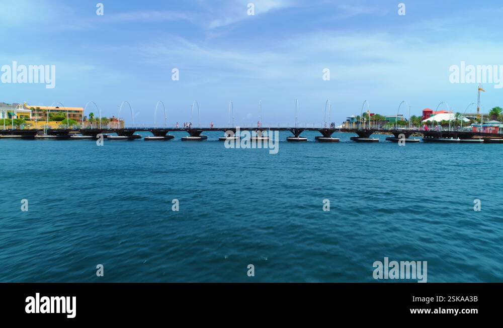 4k drone shot of the floating pontoon Queen Emma Bridge, tourists and ...