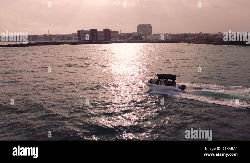 Friends water skiing over inflatable donut pulled by boat Stock Video ...