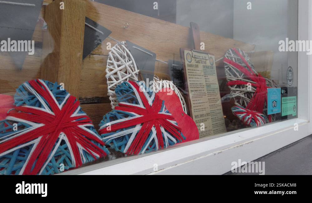 Union Jacks woven over frames in a window of a shop. Daytime, bright ...