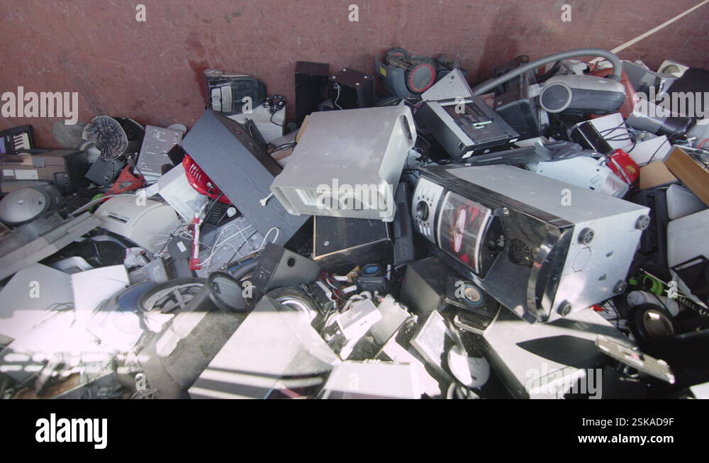 Broken PC and CD player thrown onto heap of other discarded electronics ...