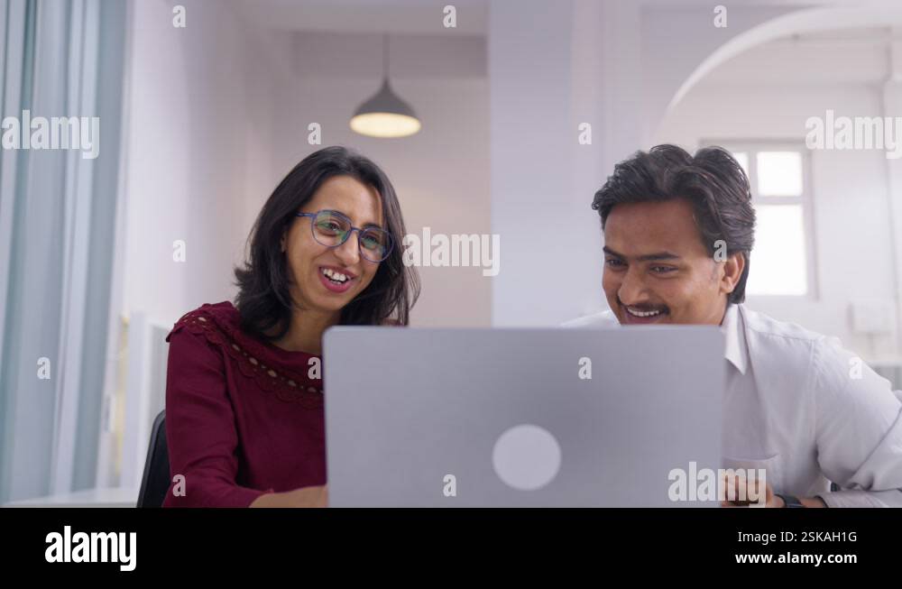 Two Indian female male office executives working together in corporate ...