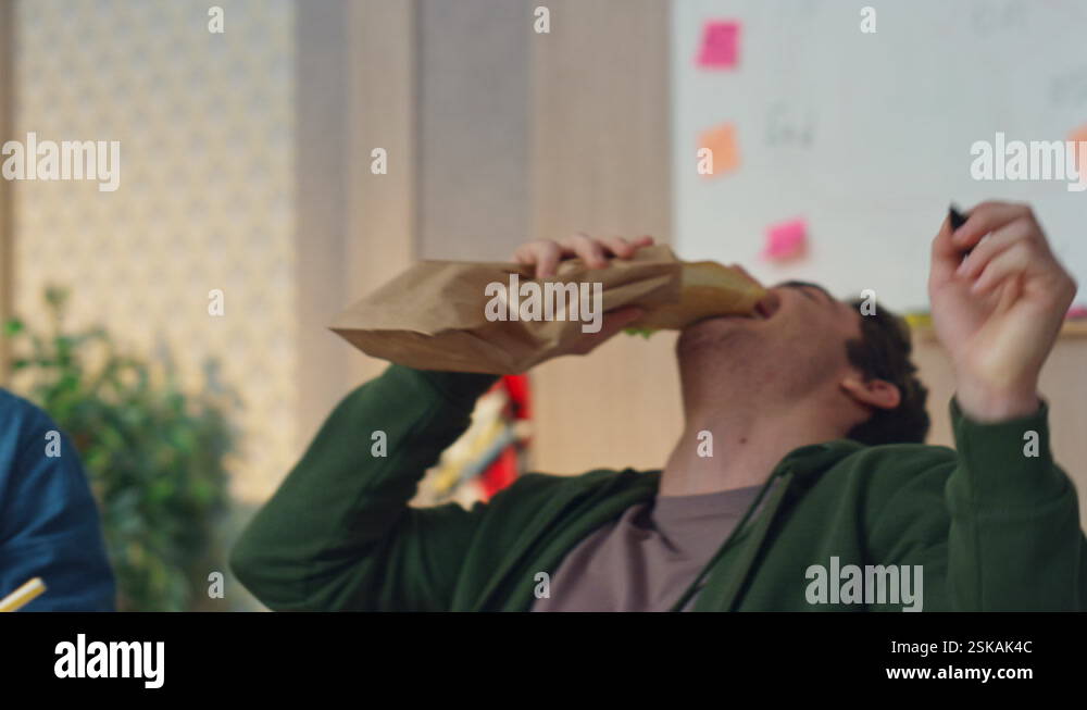 Laughing guys reacting emotionally at lunch break close up. Designers ...