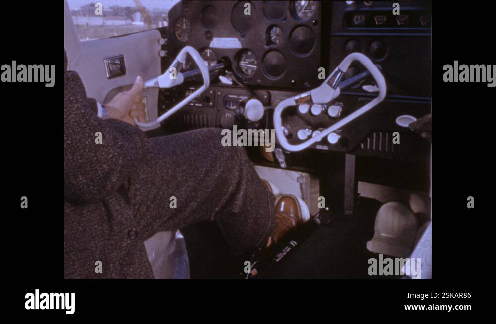 1960s: Man in airplane cockpit, steering columns moving Stock Video ...