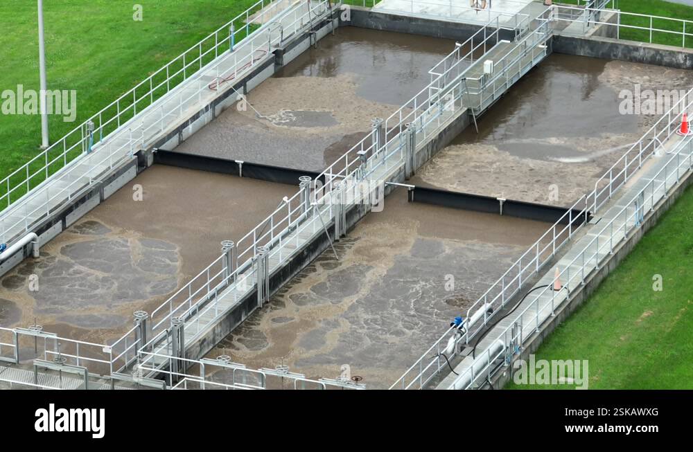 Sewage in filtration tanks at wastewater treatment plant in USA. Aerial ...