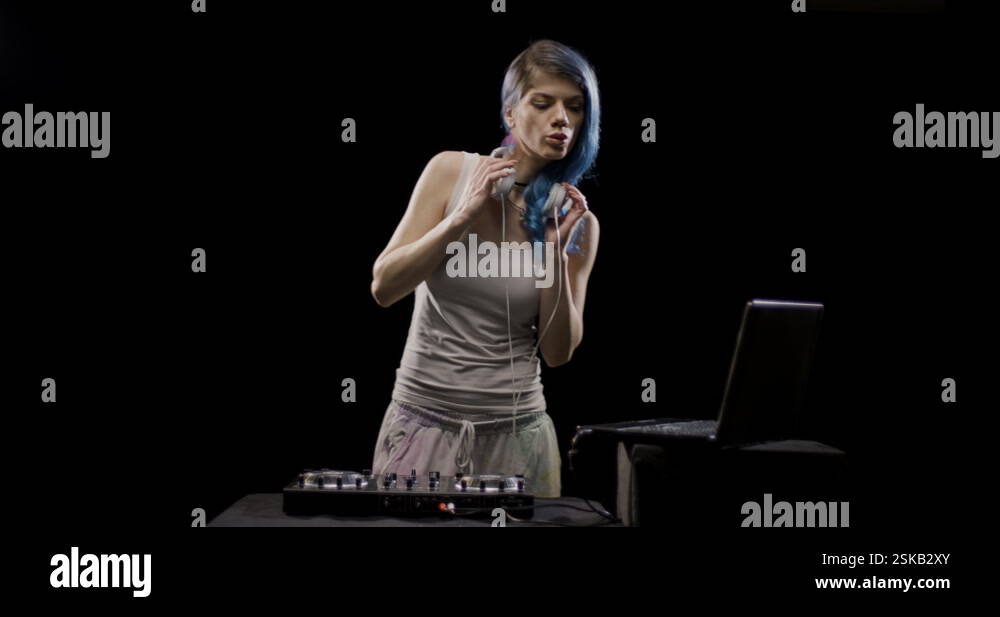 Female DJ on a mixer. Girl playing trance music against black ...